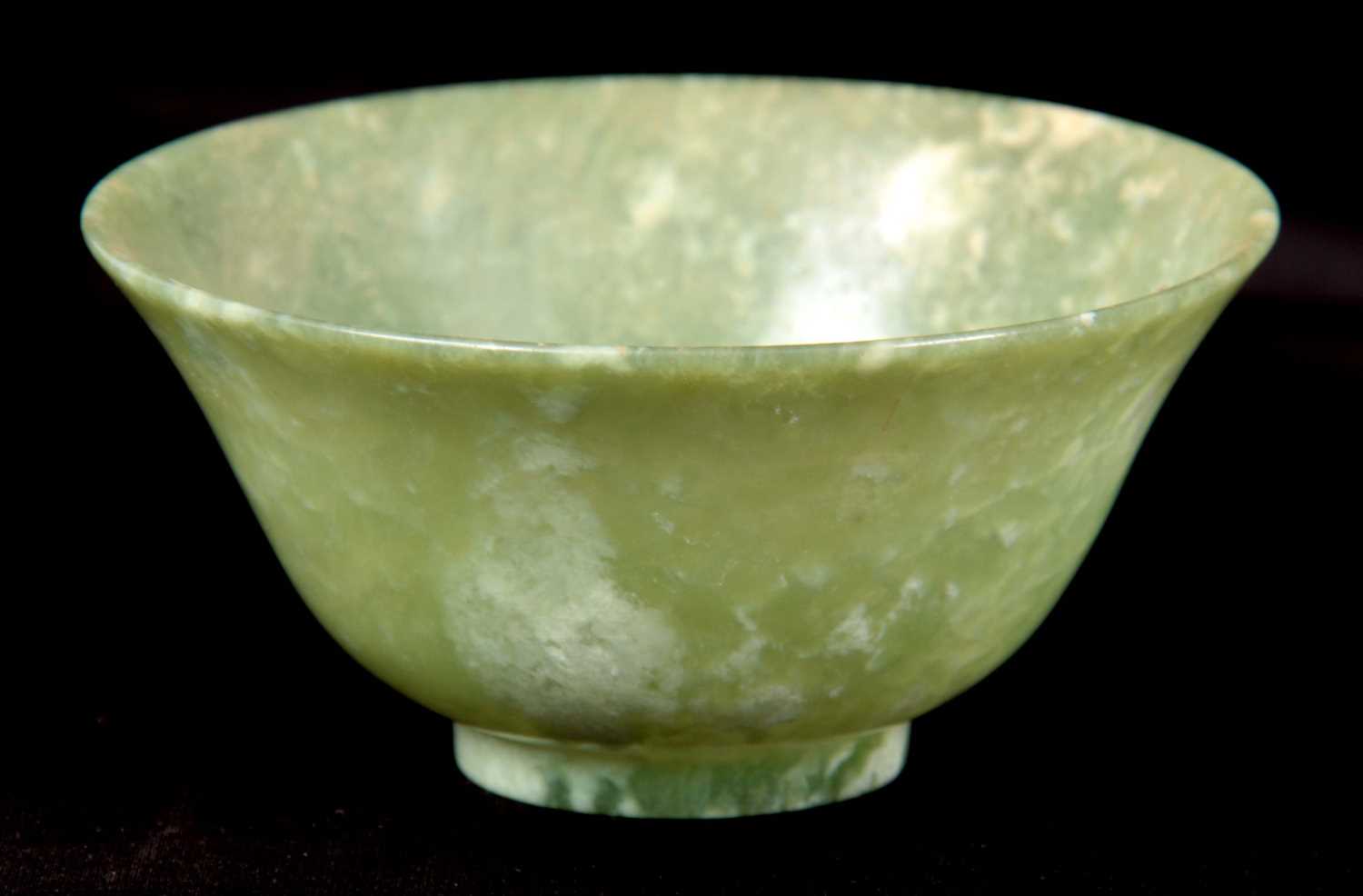Lot 120 - A CHINESE GREEN AND WHITE JADE BOWL 12cm