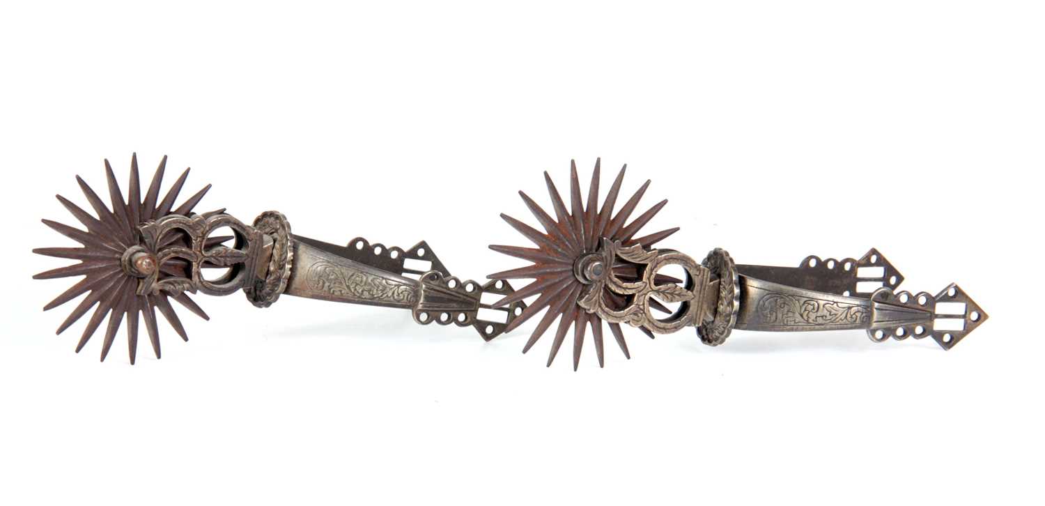 Lot 321 - A PAIR OF ENGRAVED BRASS SPURS having