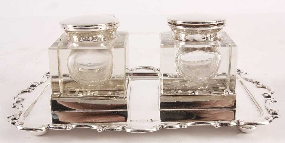 Lot 287 - AN EDWARDIAN SILVER INK STAND with scroll