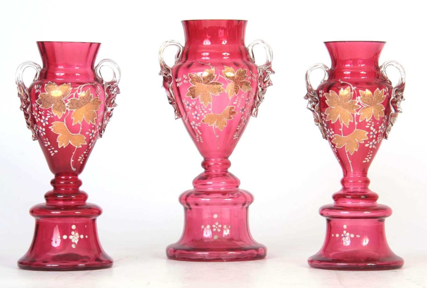 Lot 4 - A GARNITURE OF THREE VICTORIAN CRANBERRY VASES