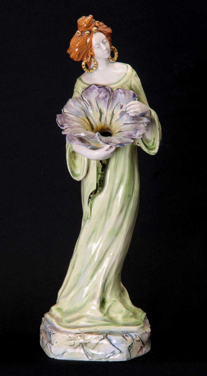 Lot 40 - AN ART NOUVEAU GLAZED POTTERY FIGURE modelled