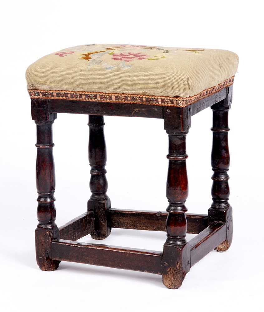Lot 738 - AN 18TH CENTURY JOINT OAK UPHOLSTERED STOOL