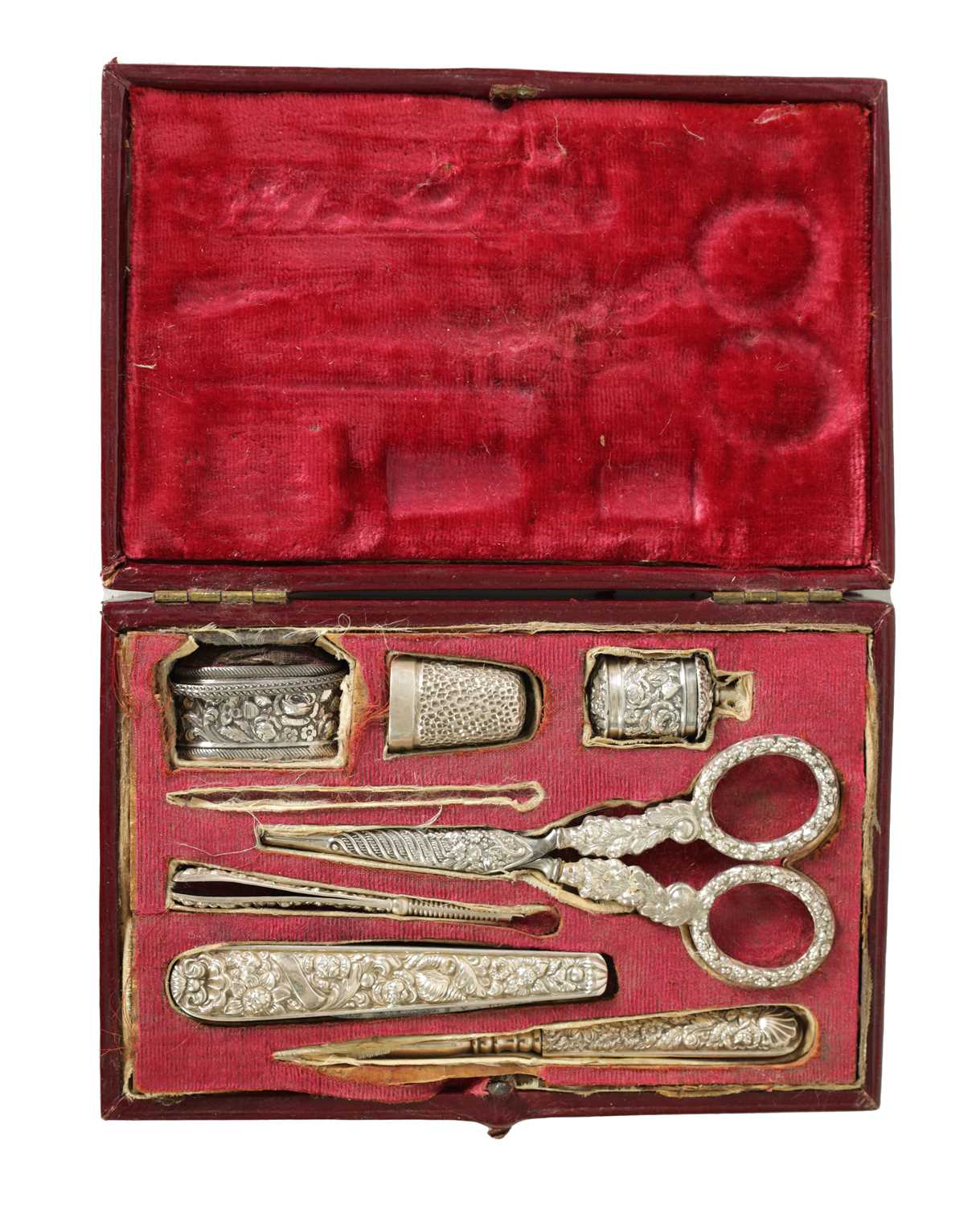 Lot 394 - A 19TH-CENTURY CASED EMBOSSED SILVER SEWING