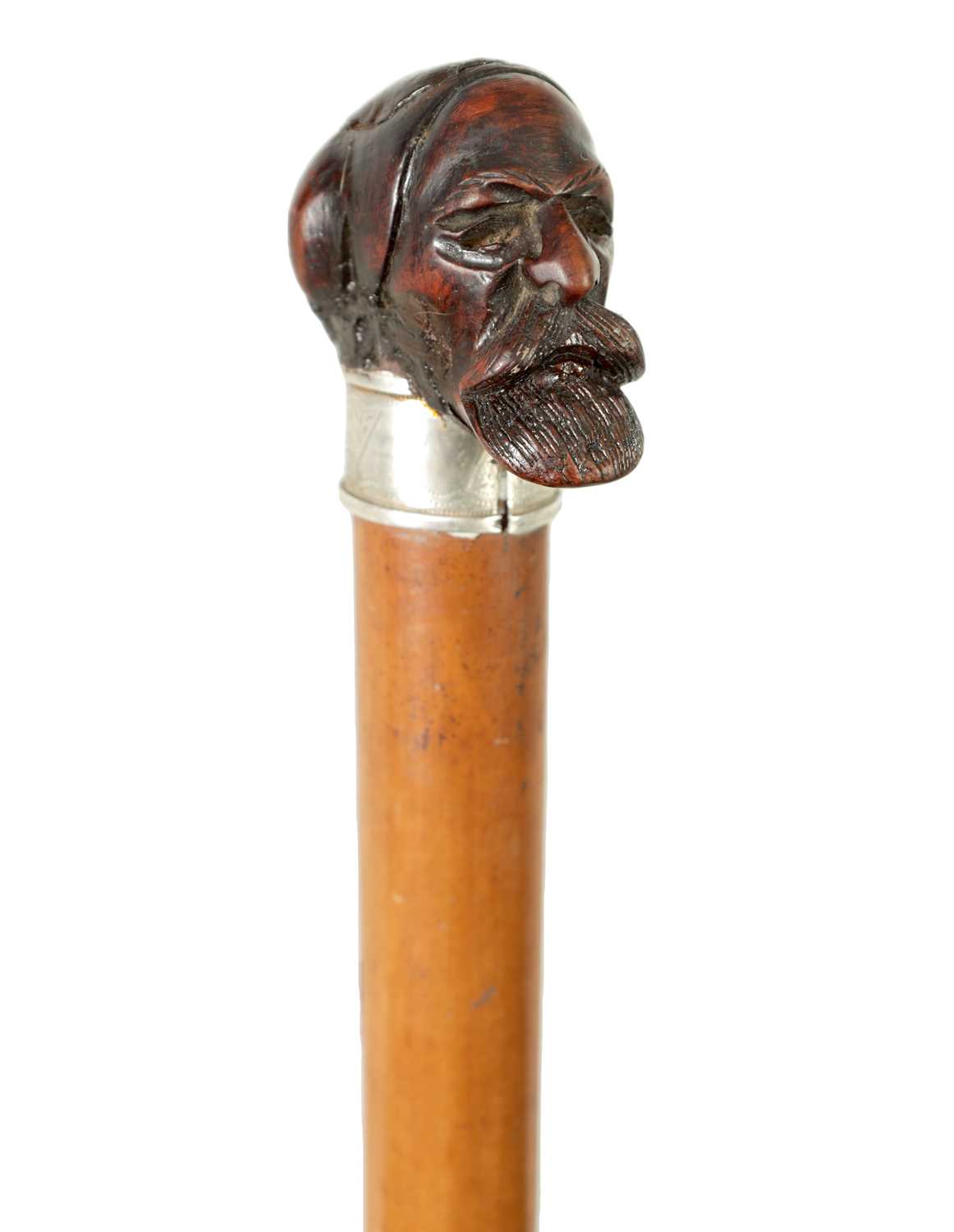 Lot 676 - A 19TH CENTURY CARVED HANDLED MALACCA CANE