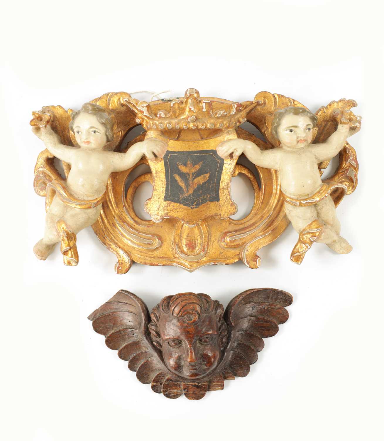Lot 1097 - A 17TH CENTURY OAK WINGED ANGELS HEAD