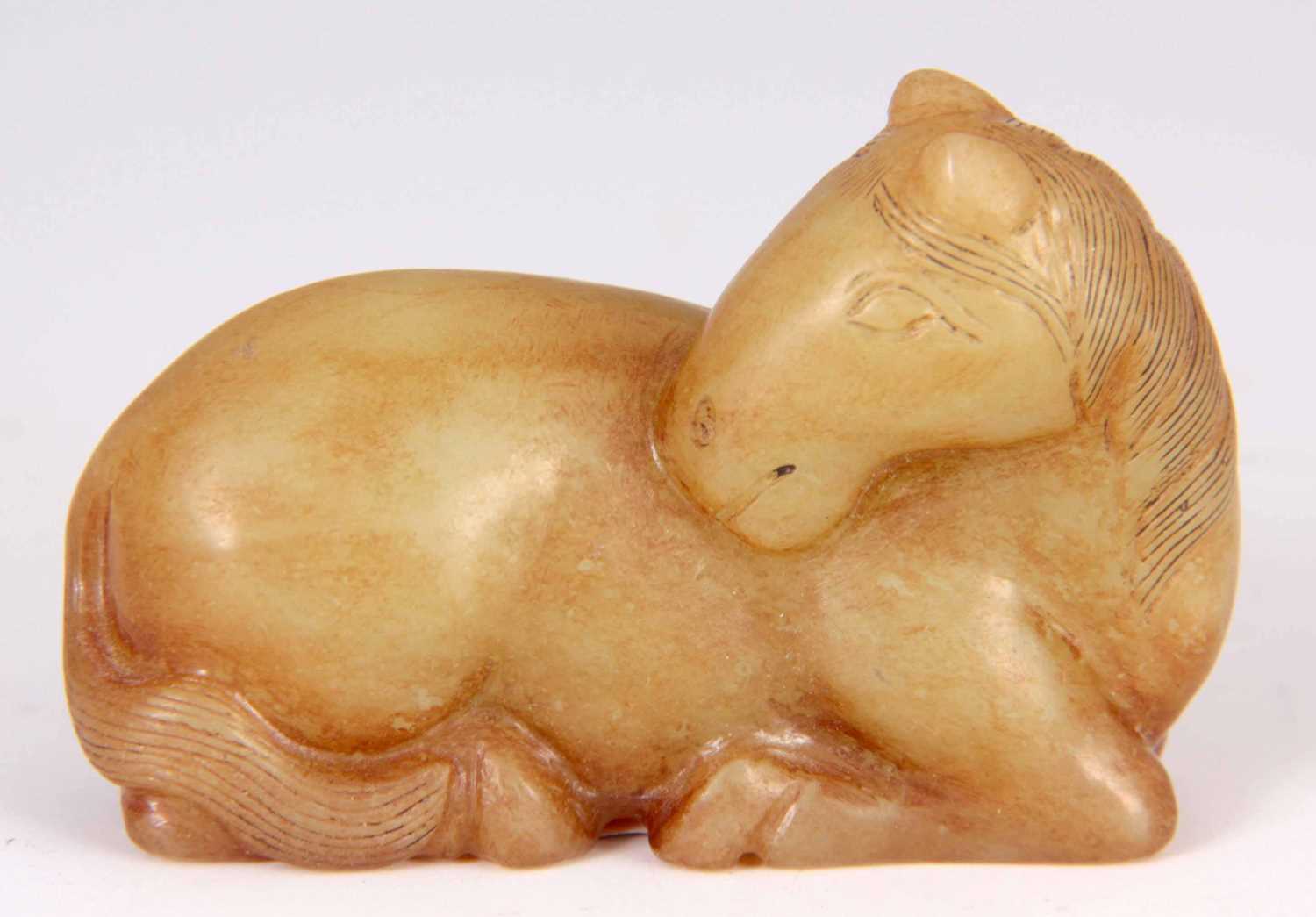 Lot 161 - A CHINESE CARVED RUST JADE SCULPTURE OF A