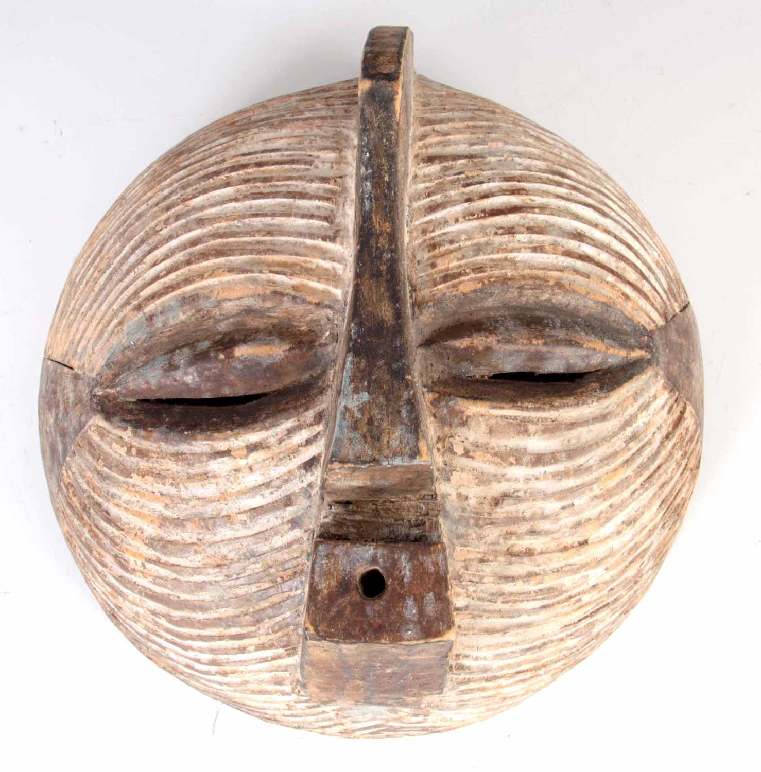 Lot 427 - AN AFRICAN CARVED WOOD LUBA MASK of circular