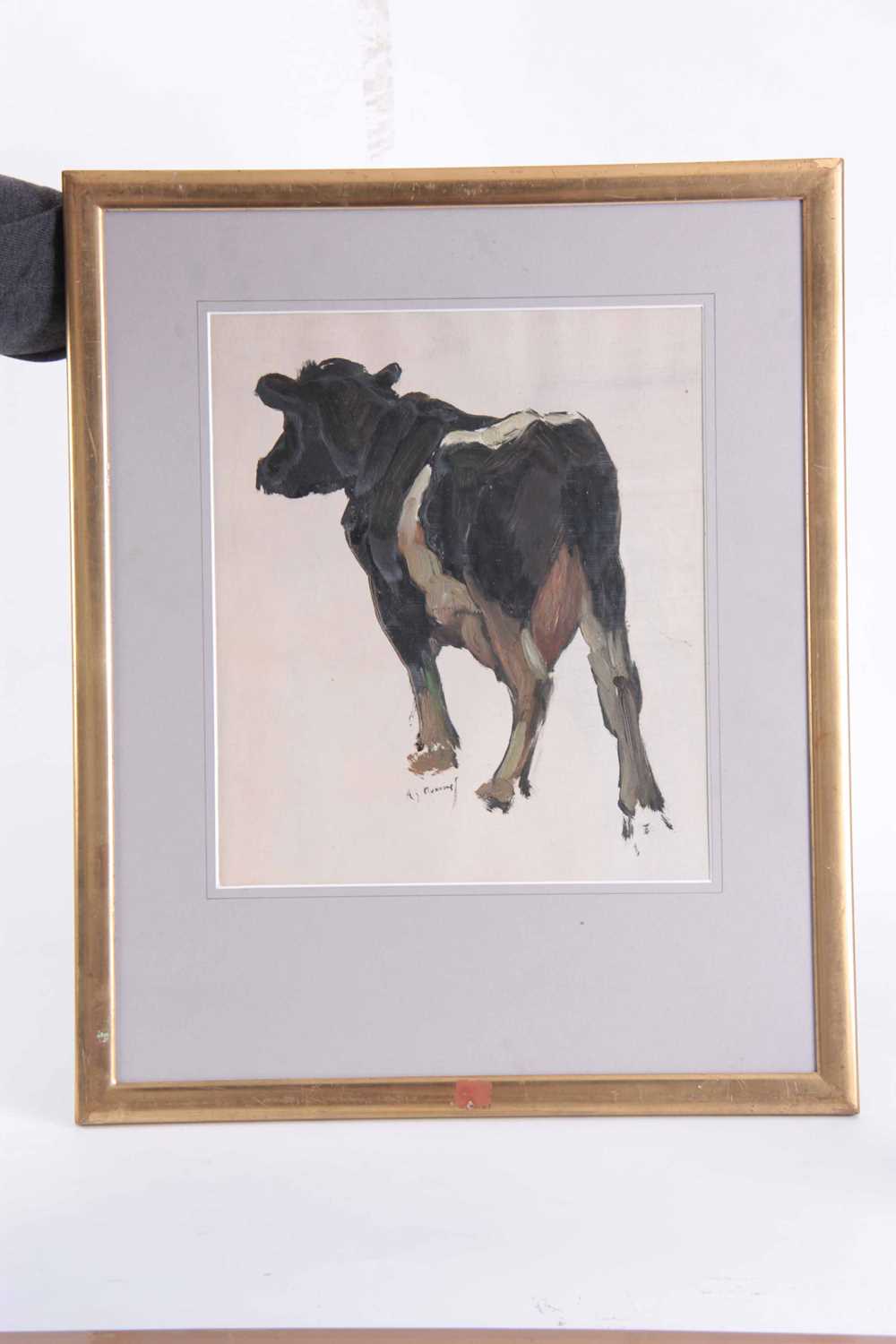 Lot 355 - A 20TH CENTURY OIL ON PAPER DEPICTING A COW